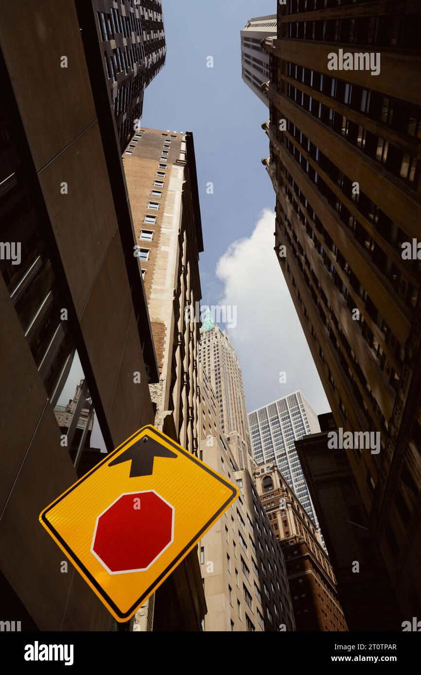 low angle view of road sign, tall buildings and skyscrapers in new york ...