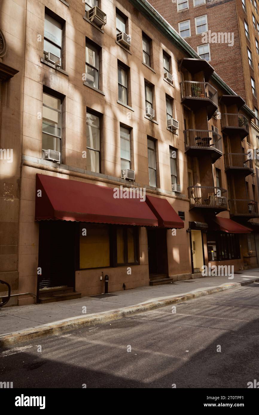 low story stone building with balconies on narrow and cozy street, new ...