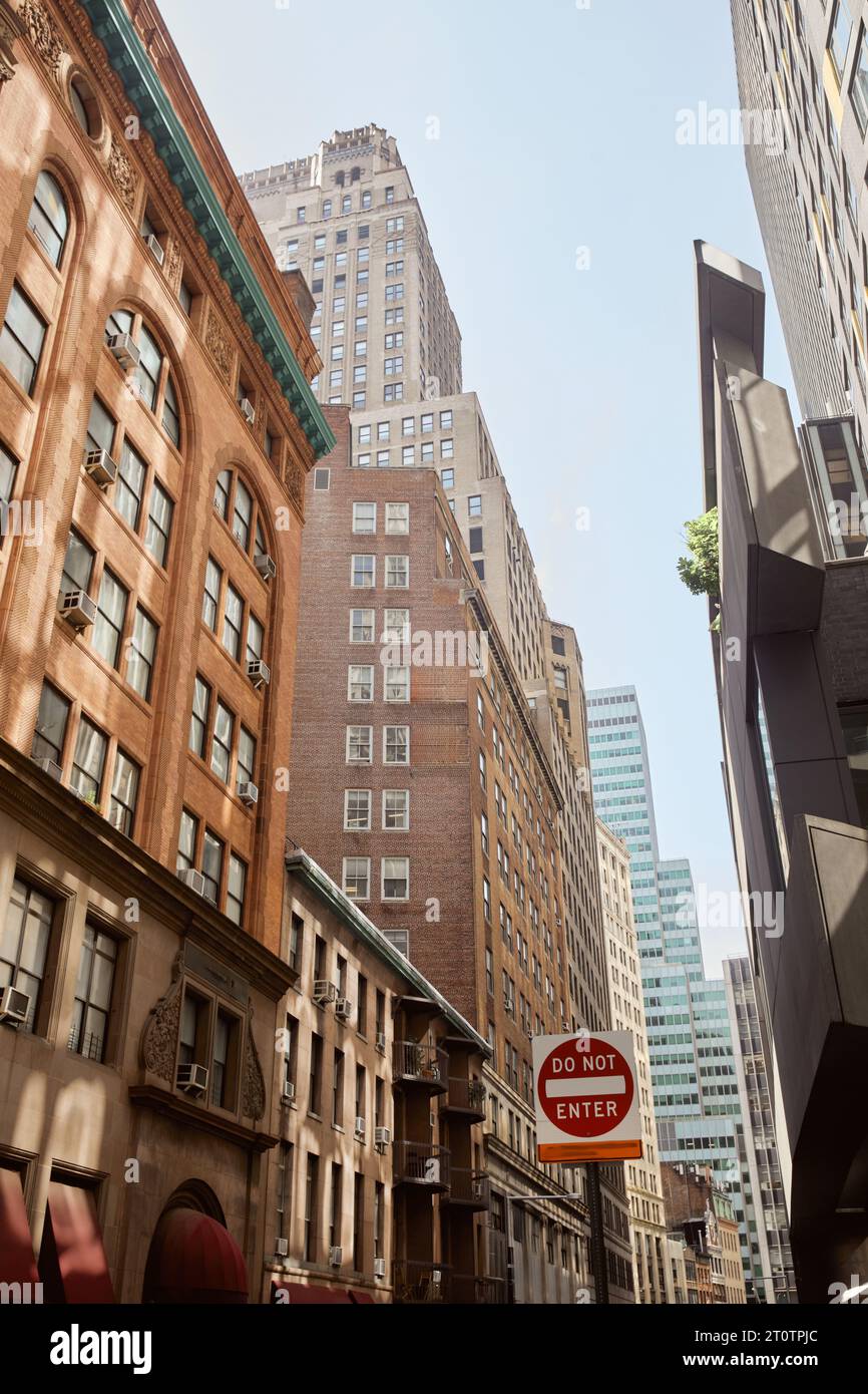 do not enter sign on avenue with modern and vintage buildings in new ...