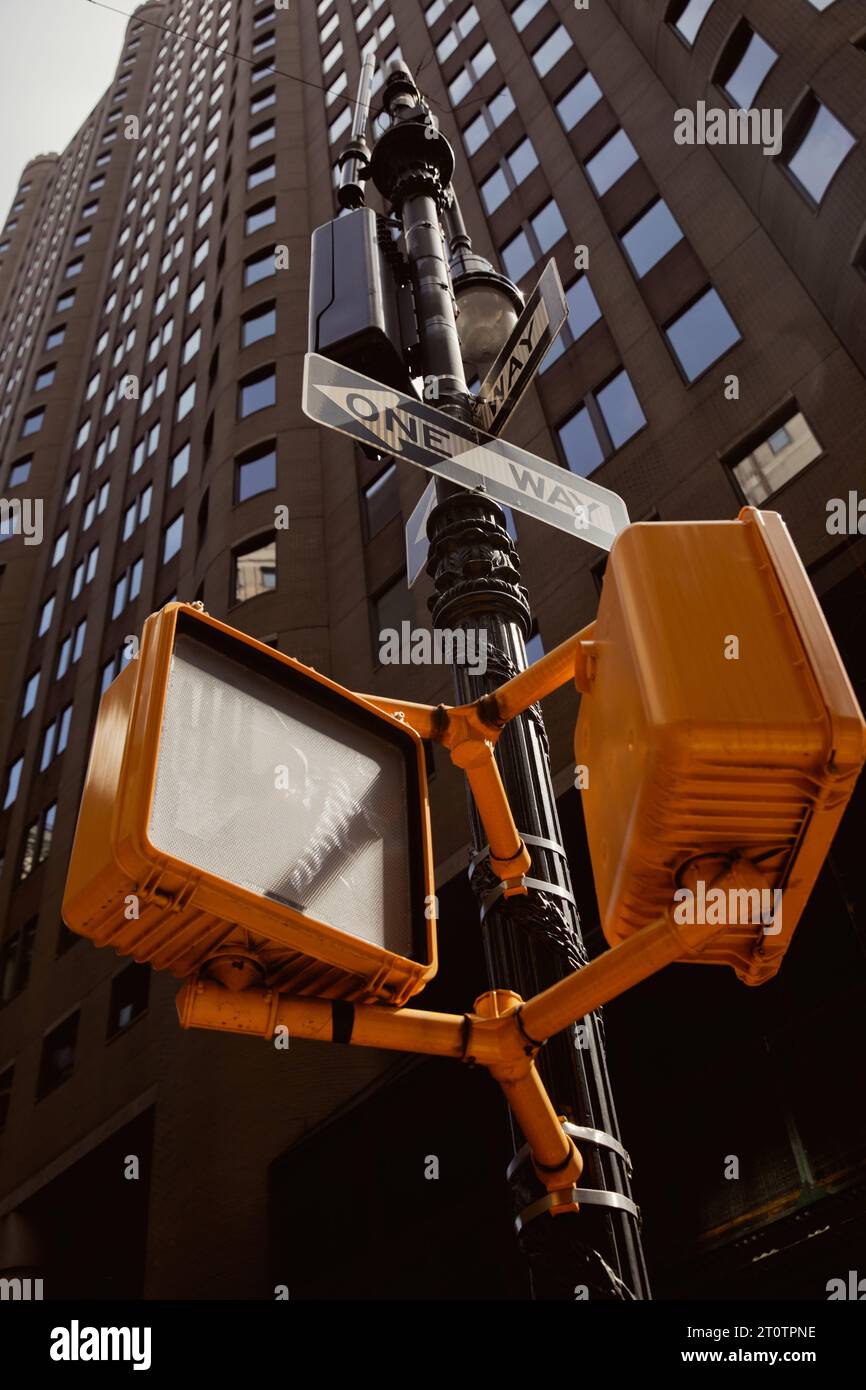 street pole with traffic lights and road signs near modern building in ...