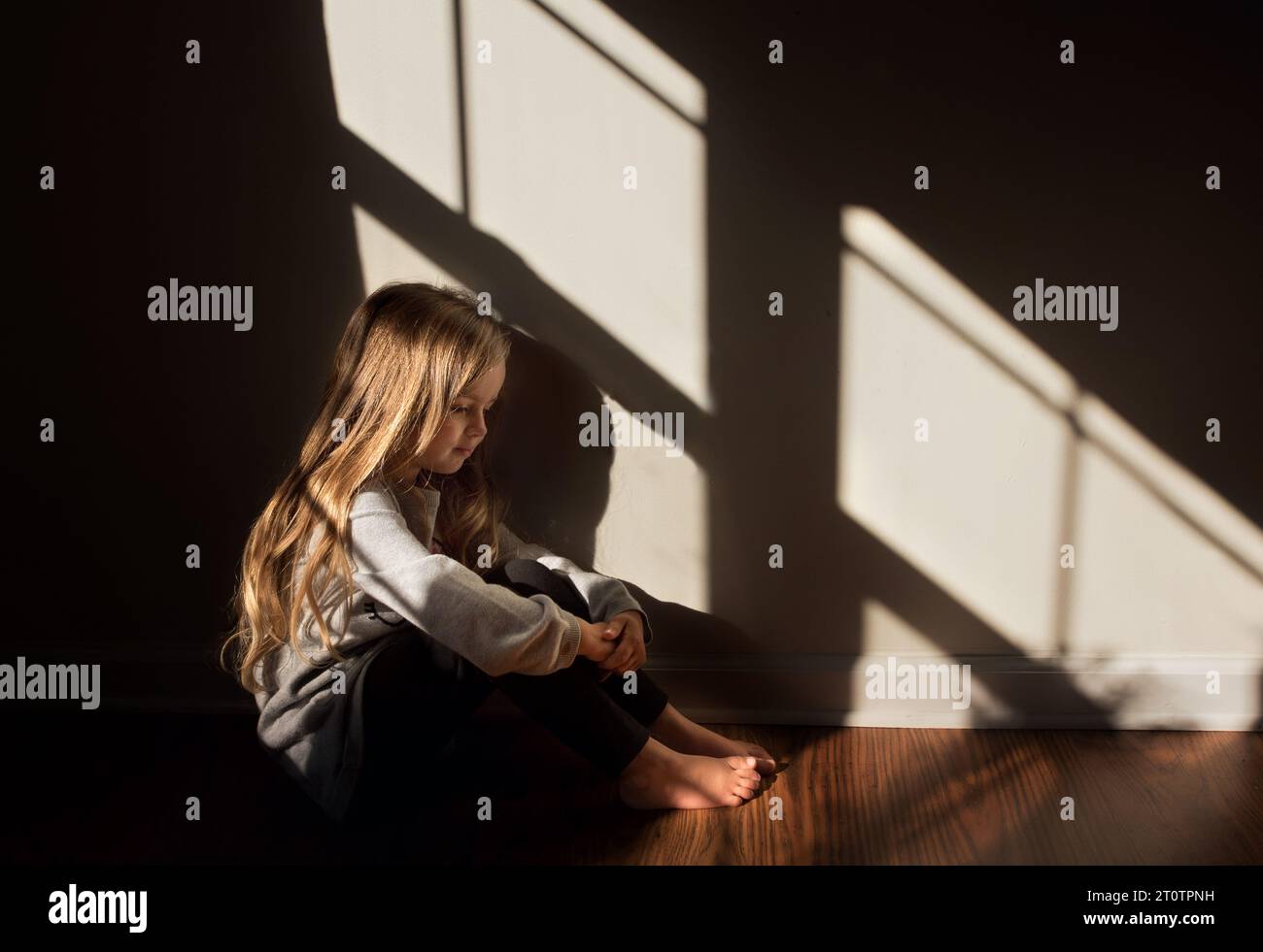 Young girl sitting quietly in beautiful light Stock Photo - Alamy