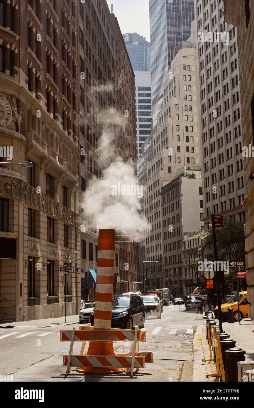 steam pipe on urban street with cars moving on roadway in new york city ...
