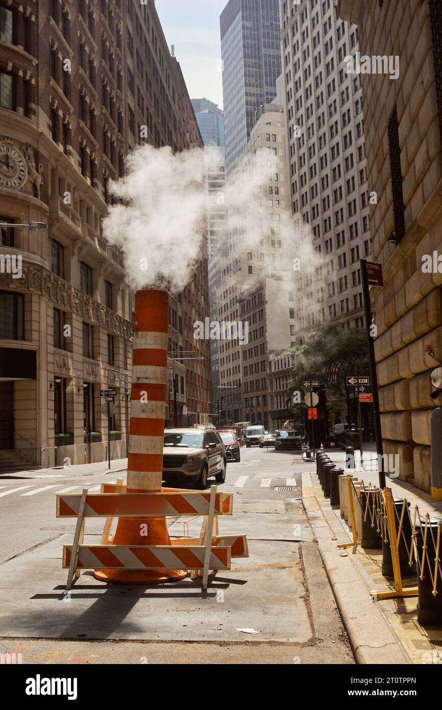 steam pipe on urban street with vehicles moving on roadway of new york ...