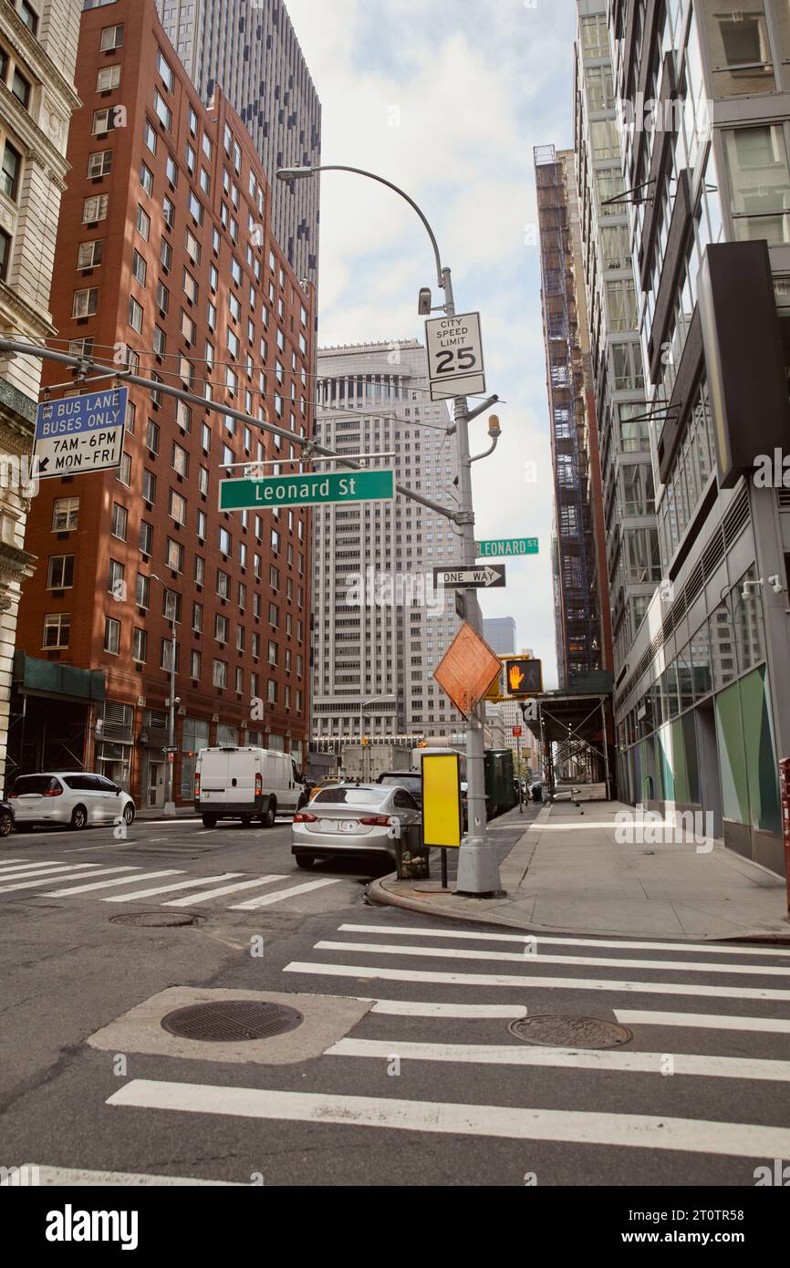 traffic signs over crosswalk and cars moving on wide roadway in new ...