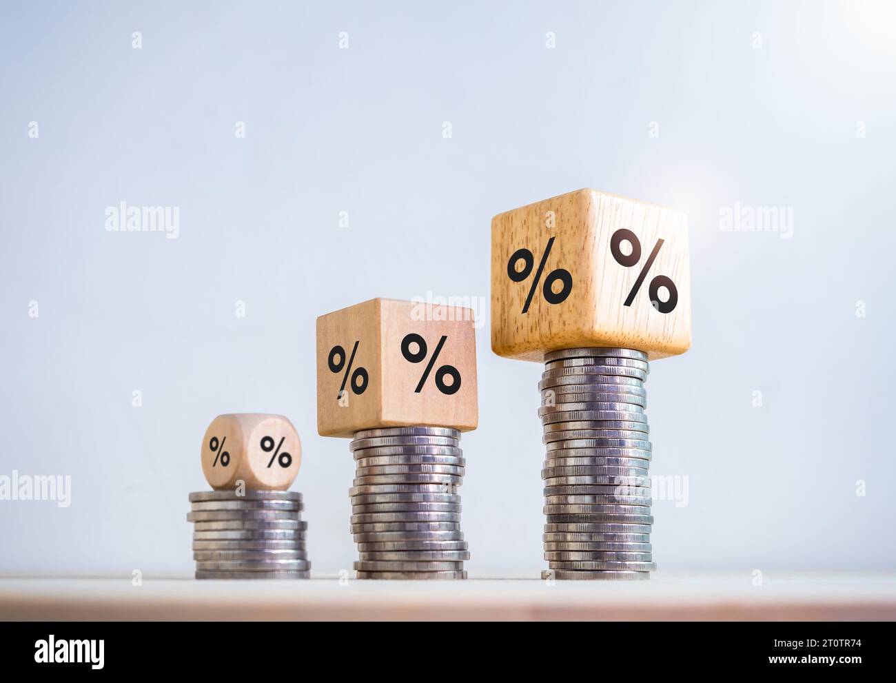 Percentage icon on wooden cube blocks expanding on coin stacked bar ...