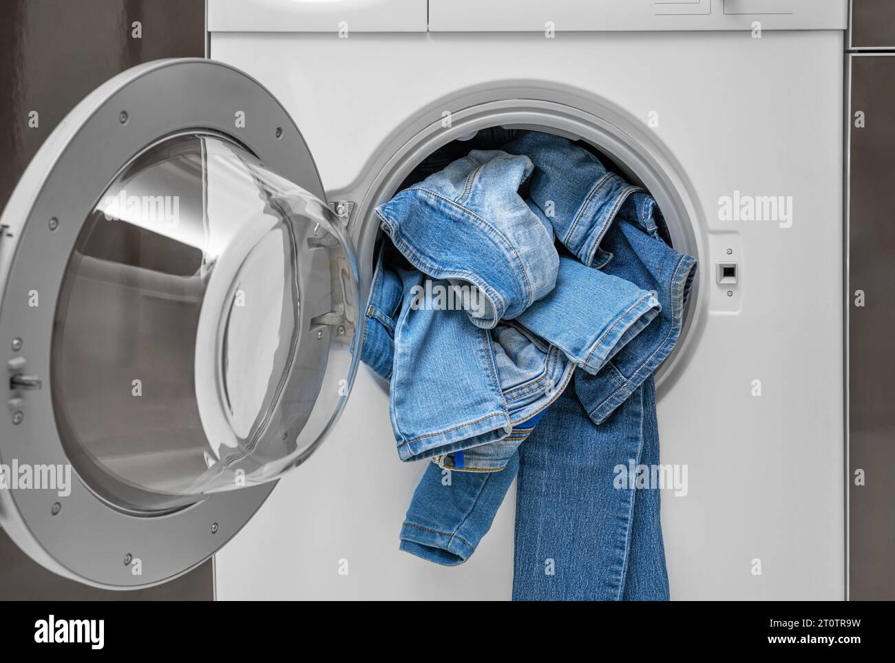 Washing denim in a washing machine Stock Photo - Alamy