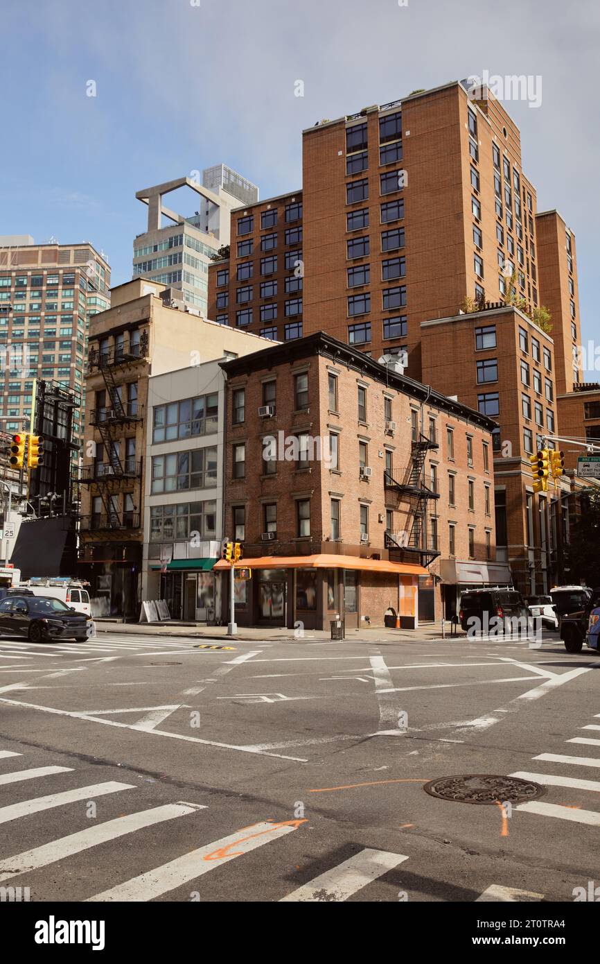 different style buildings near crossroad with moving cars in new york ...