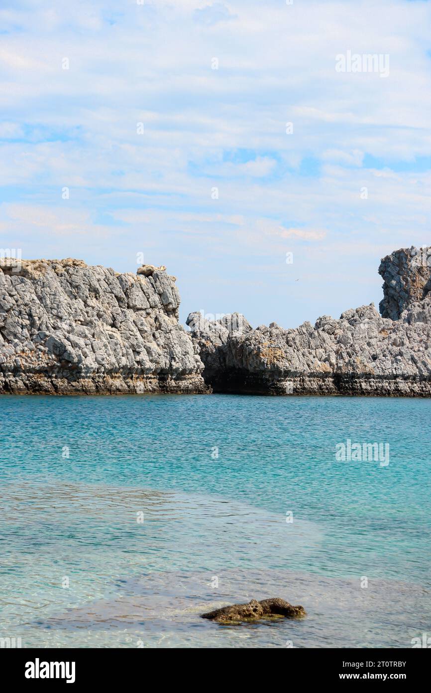 View of Saint Paul's Bay beach rock formation hill in the ocean water ...
