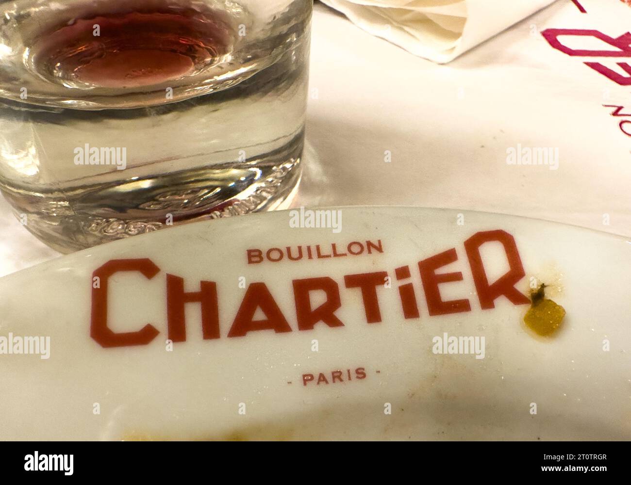 The logo on a plate and an empty wine glass after a meal at the ...