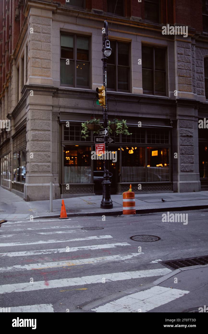 street pole with traffic lights and flowerpots near building with ...