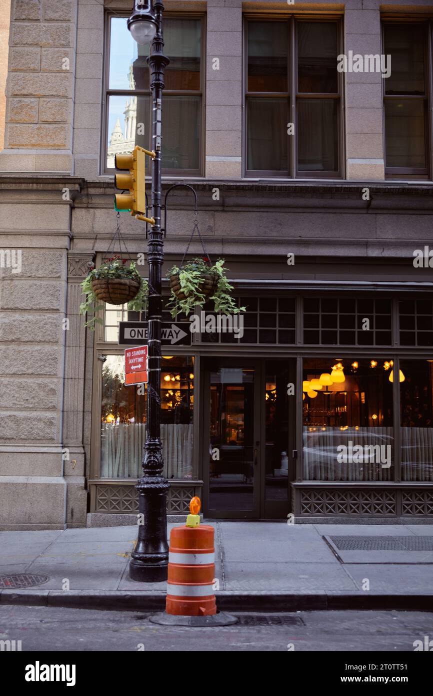 building with restaurant near street pole with traffic lights and ...