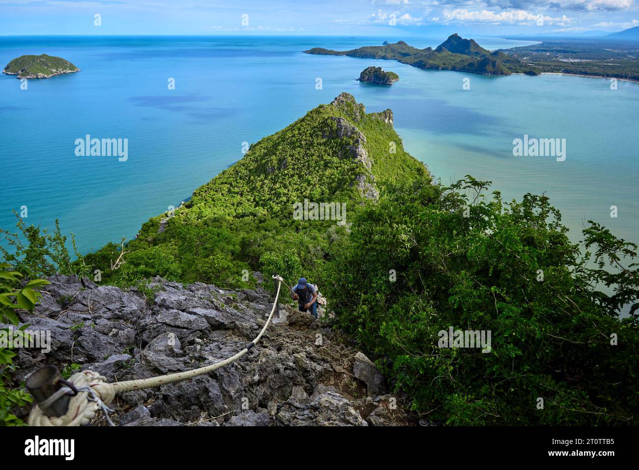 Young man rope climbing rocky hi-res stock photography and images - Alamy