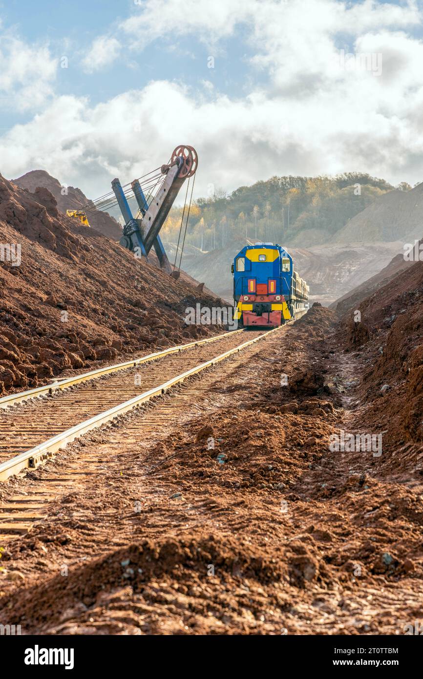 A train driving past an excavator Stock Photo - Alamy