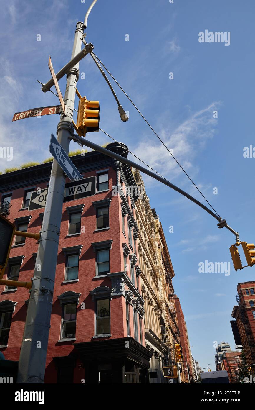 low angle view of street pole with road signs and traffic lights near ...