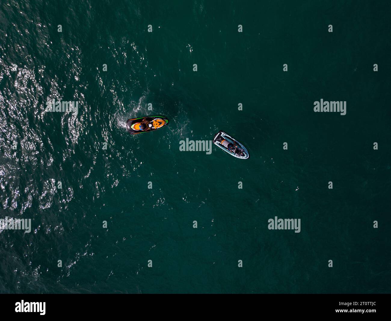 Aerial top view of a personal watercraft speeding through the waves ...