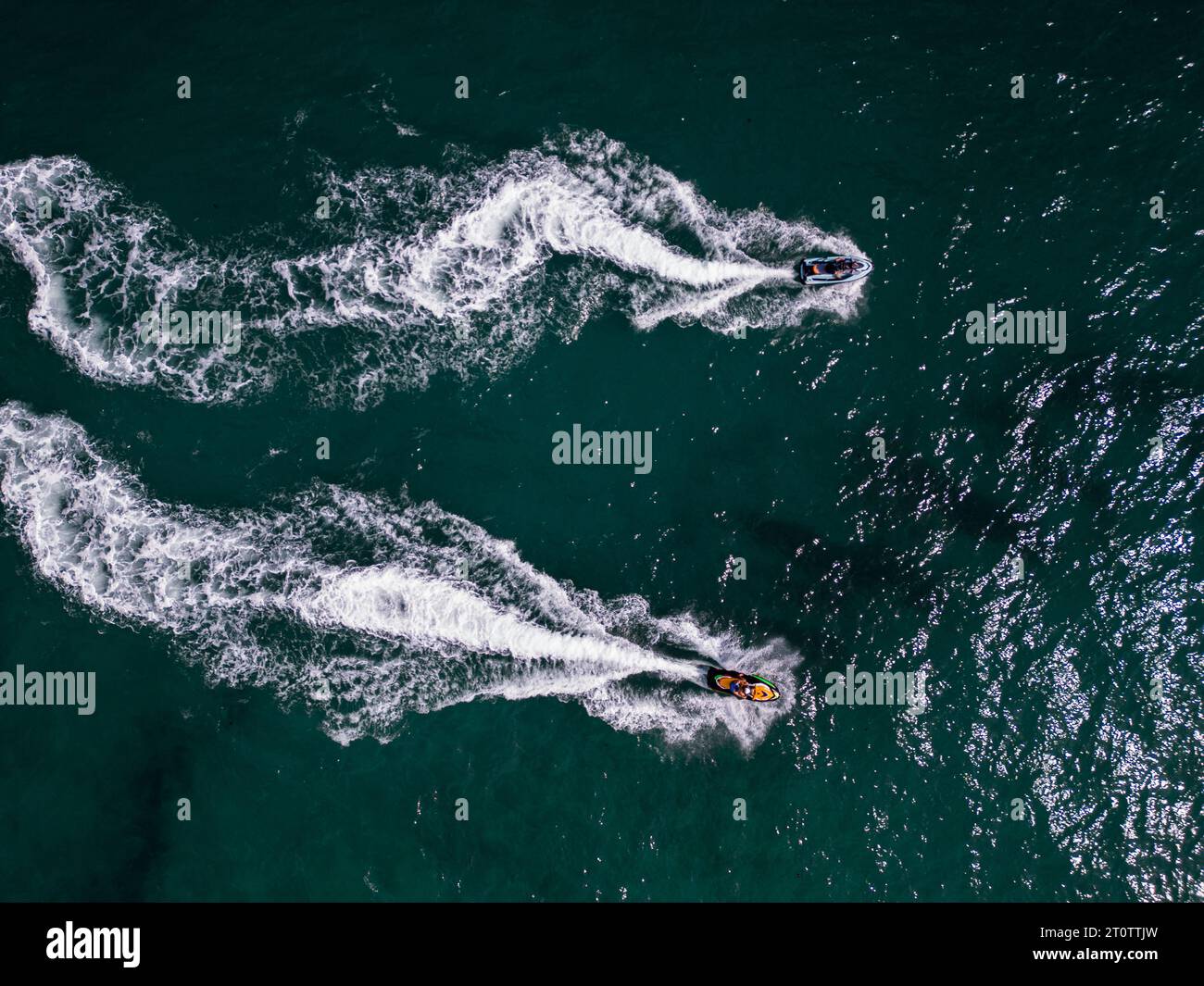 Aerial top view of a personal watercraft speeding through the waves ...