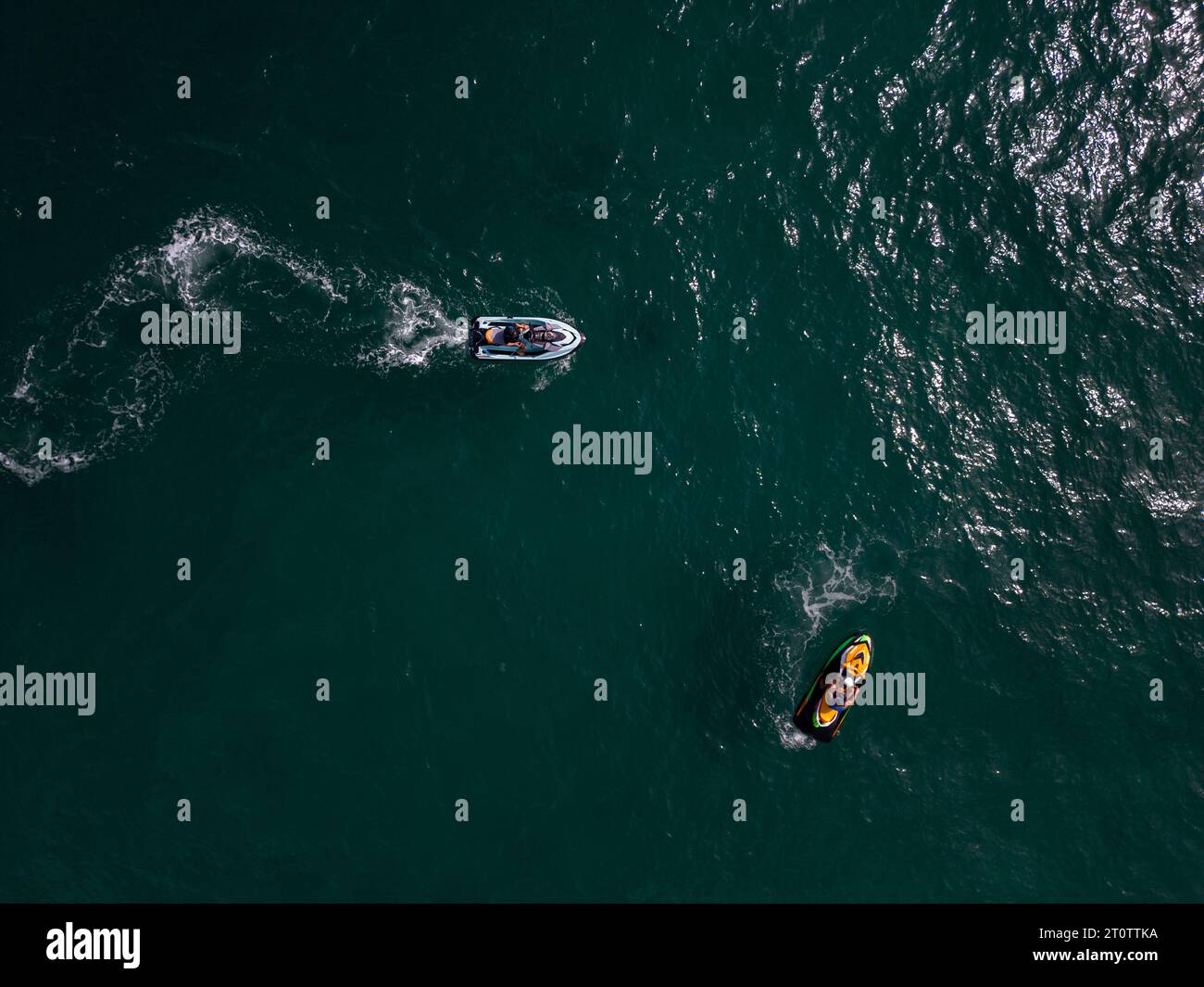 Aerial top view of a personal watercraft speeding through the waves ...