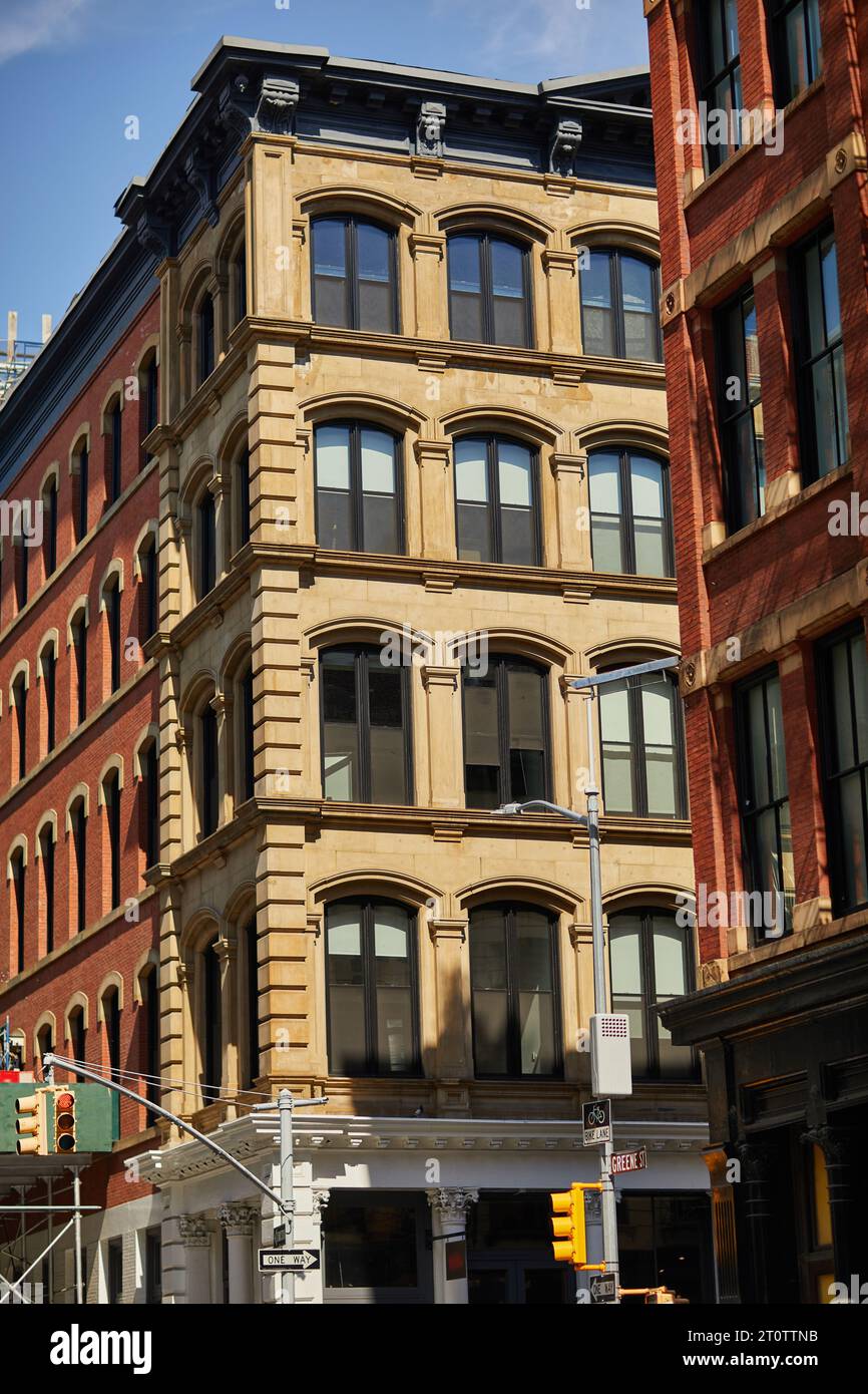 corner of vintage building with arch windows near traffic lights in ...