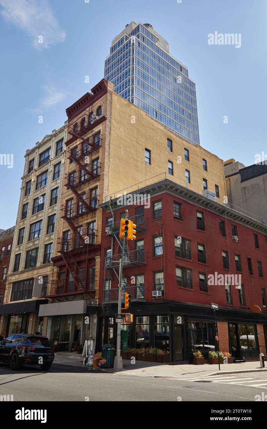 modern skyscraper and vintage buildings near road with traffic light in ...