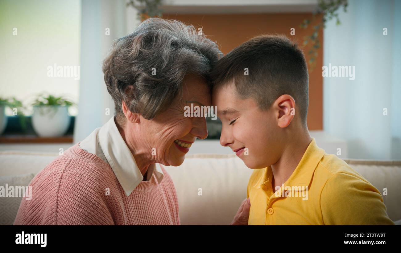 Happy loving elderly retired woman grandmother play with child kid boy ...
