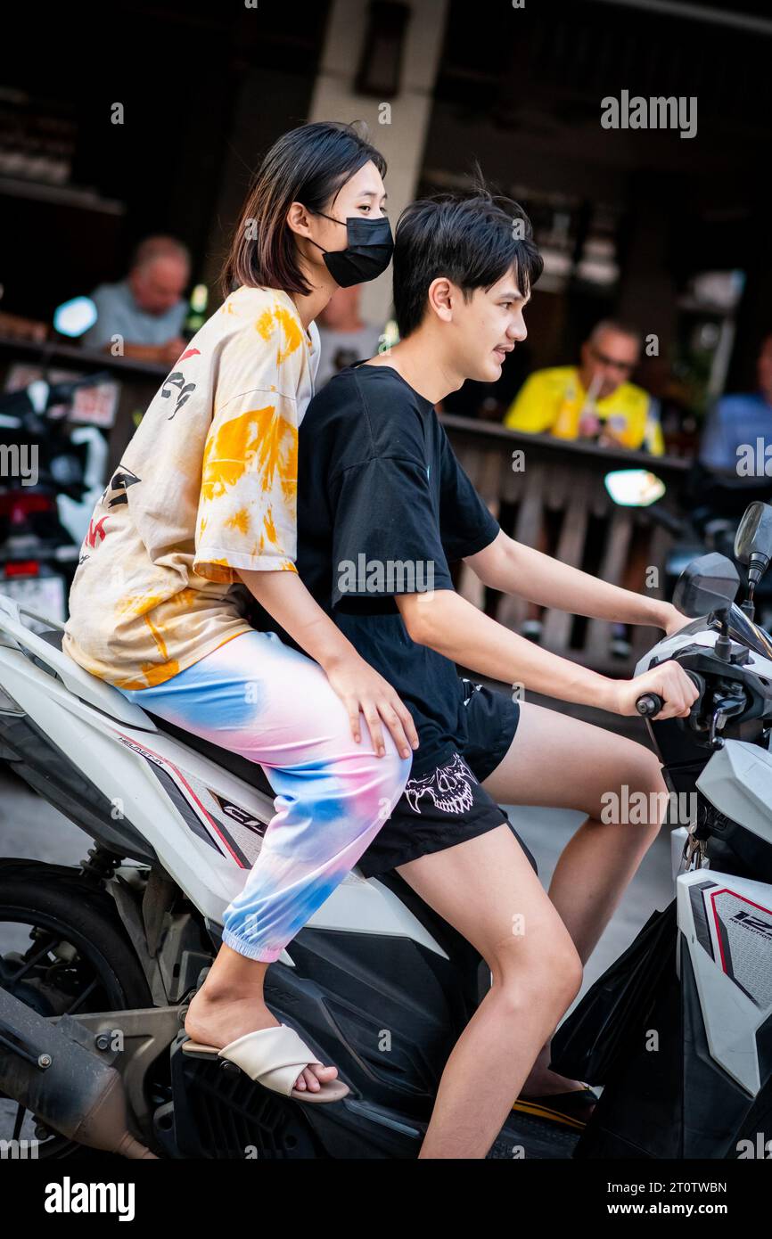 Local Thai people, tourists and residents rush past the busy junction ...