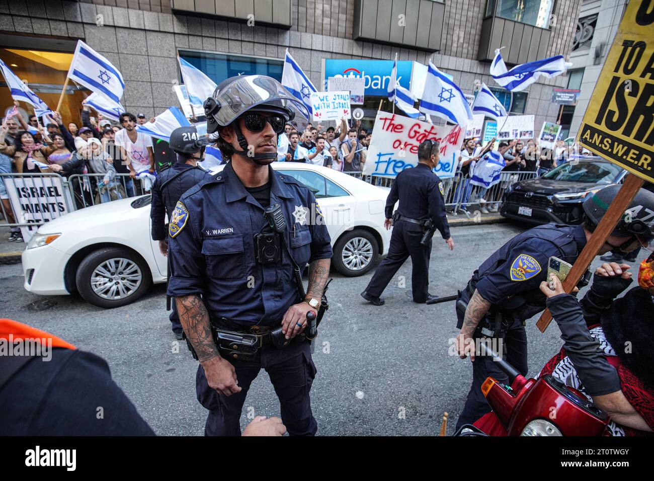 Riot policemen stand between the supporters of Palestine and Israel ...