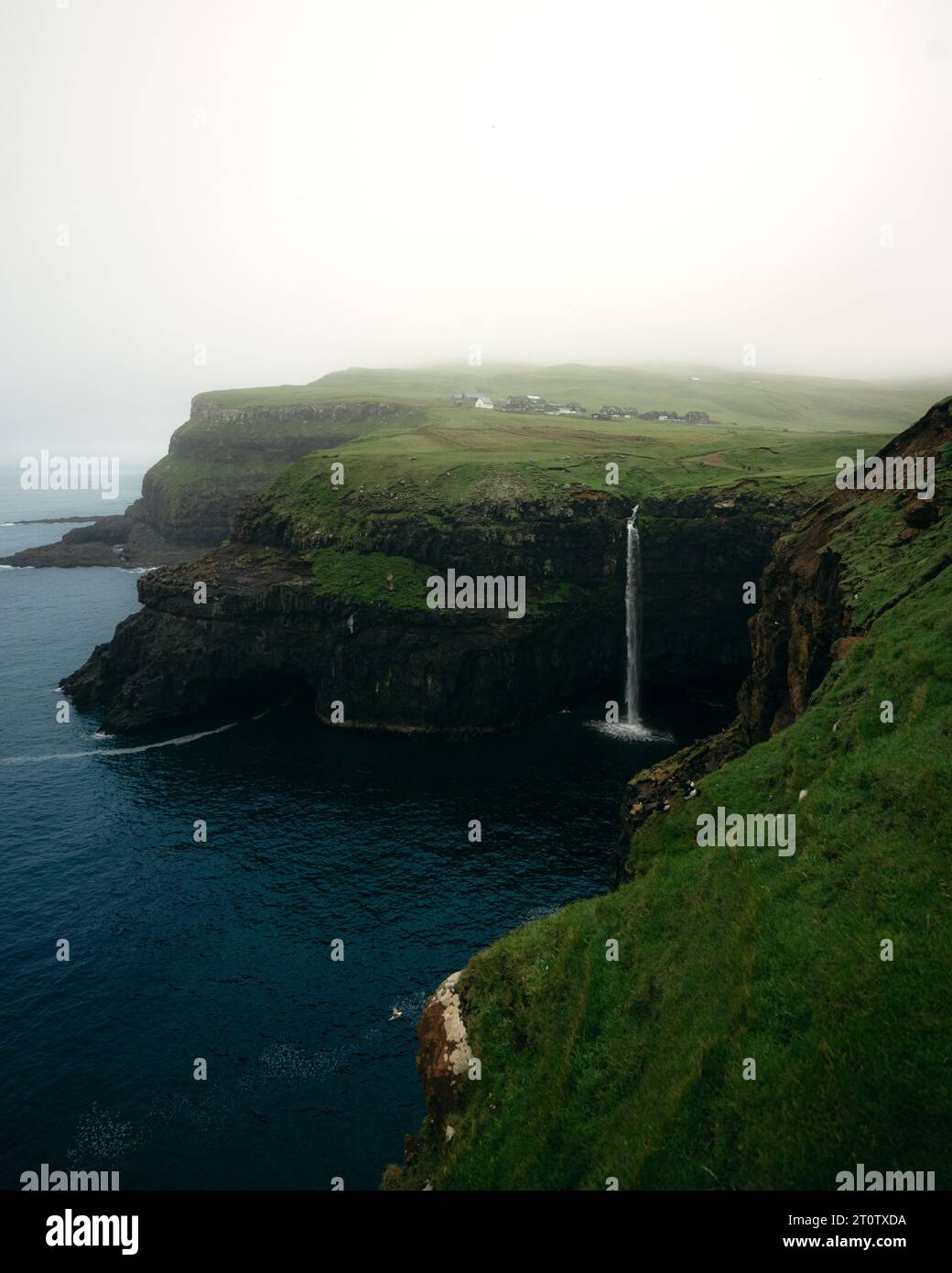 An aerial shot of Mulafossur Waterfall, located on the Faroe Islands in ...