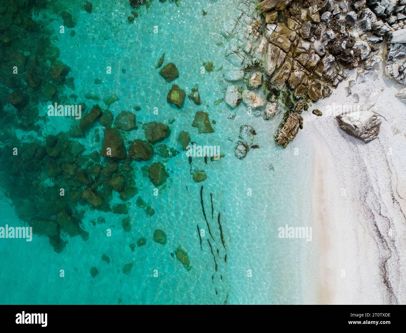 The beach with white marble pebbles and turquoise sea on the Greek ...