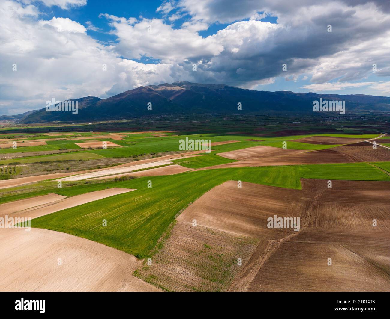 From above, the agricultural fields nestled amidst towering mountains ...