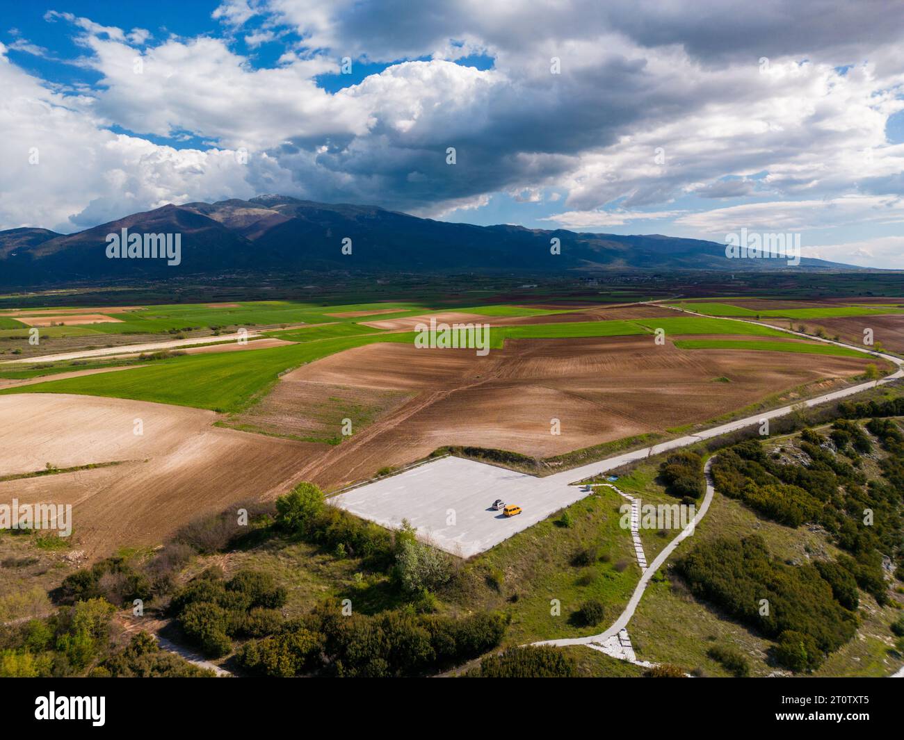 From above, the agricultural fields nestled amidst towering mountains ...