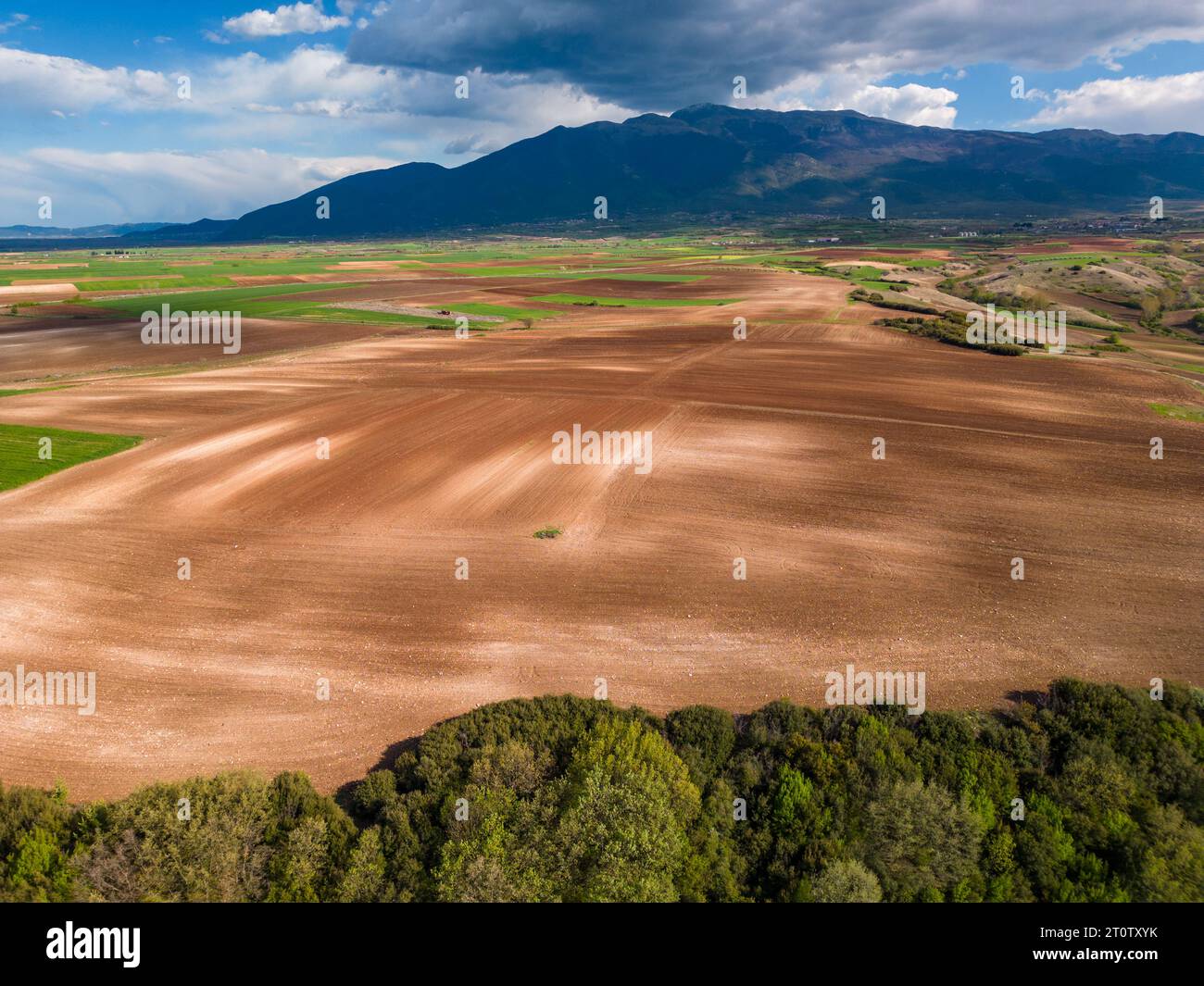 From above, the agricultural fields nestled amidst towering mountains ...