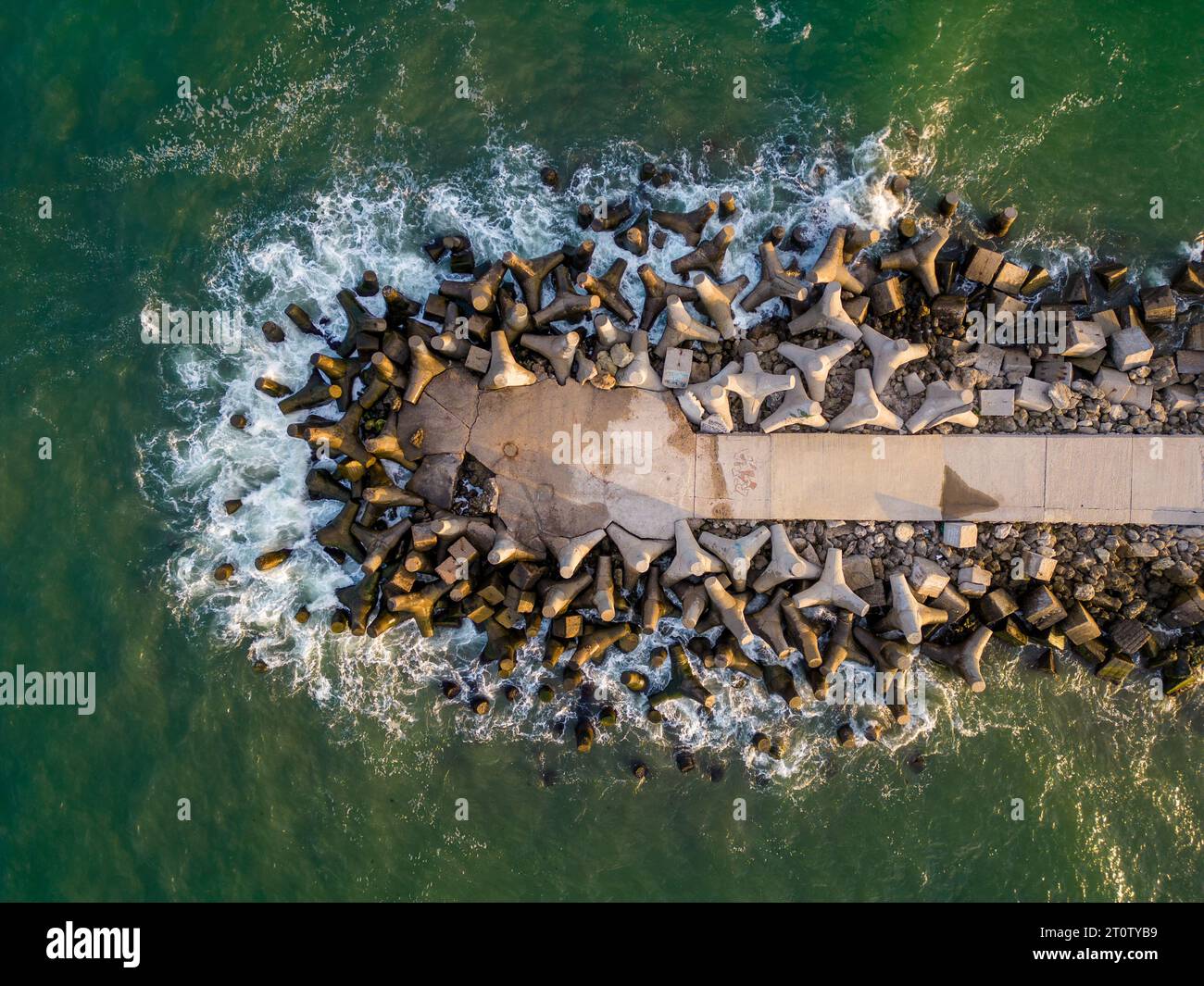 Aerial top down view of a breakwater in the sea. It's a fascinating ...