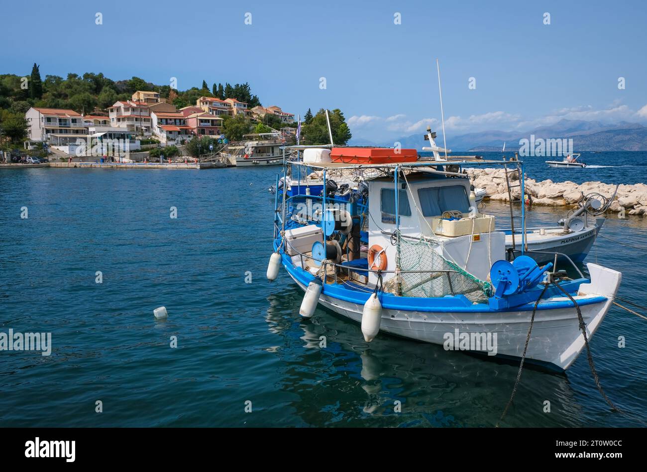 Kassiopi, Corfu, Greece - Fishing boat in the harbor of Kassiopi, a ...