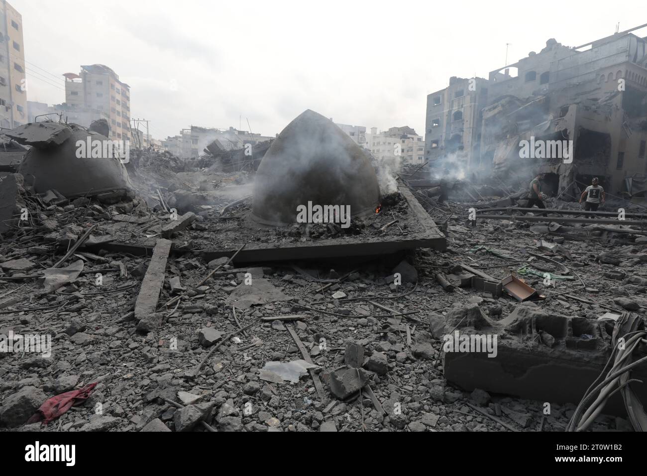 Palestinians inspect the damage following an Israeli airstrike on the ...