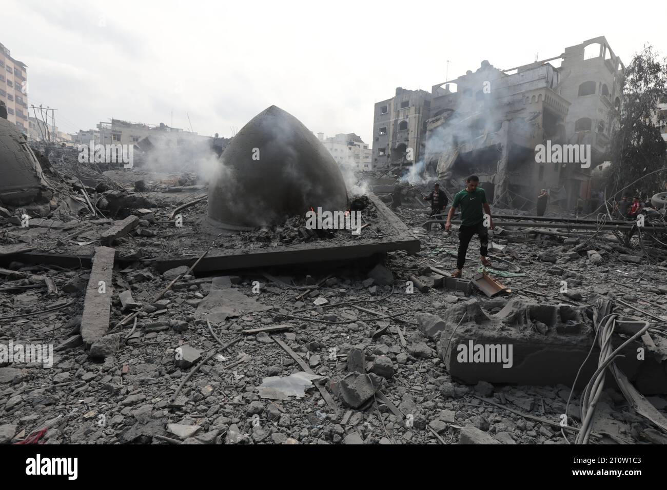 Palestinians inspect the damage following an Israeli airstrike on the ...