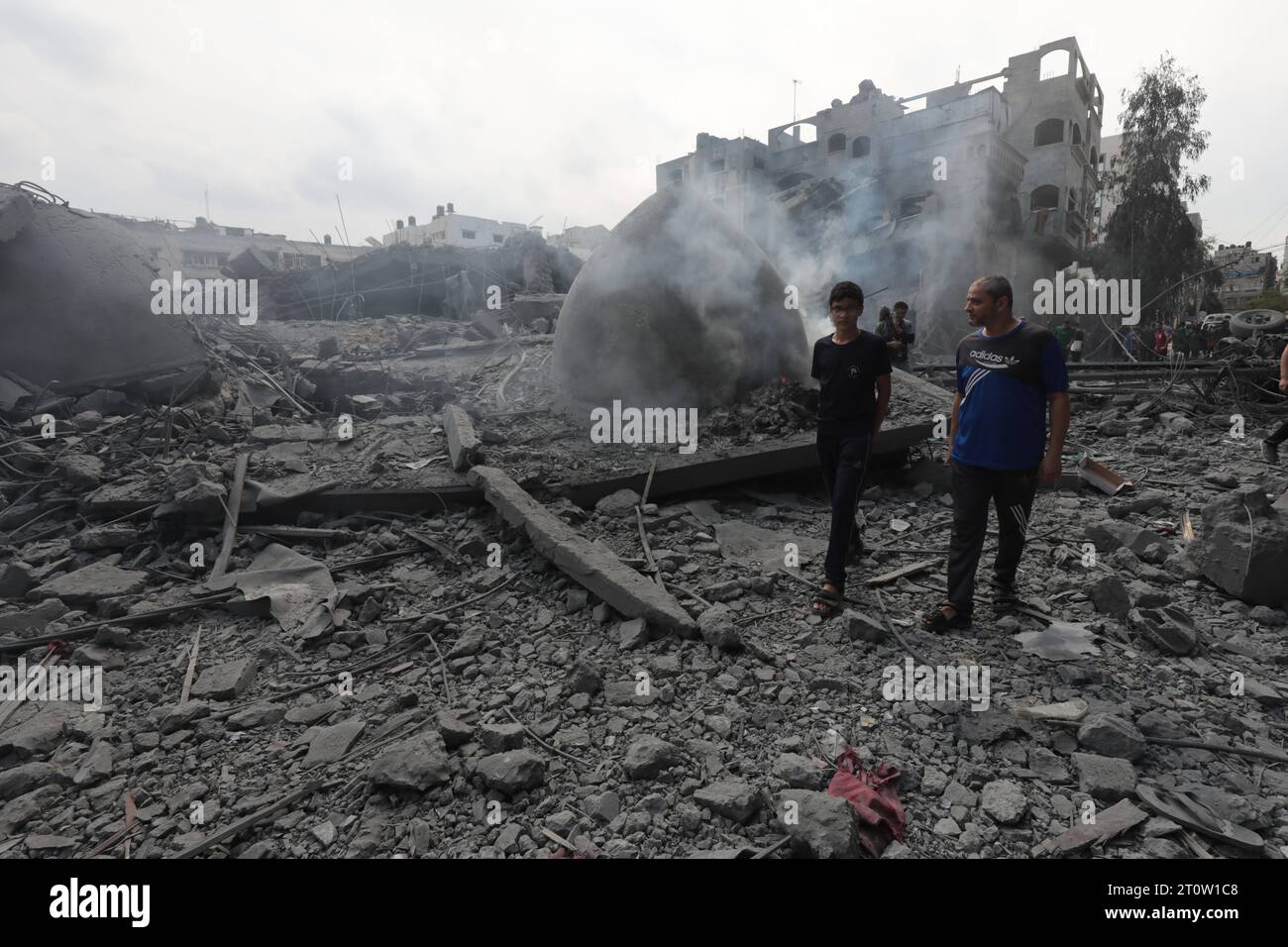 Palestinians inspect the damage following an Israeli airstrike on the ...