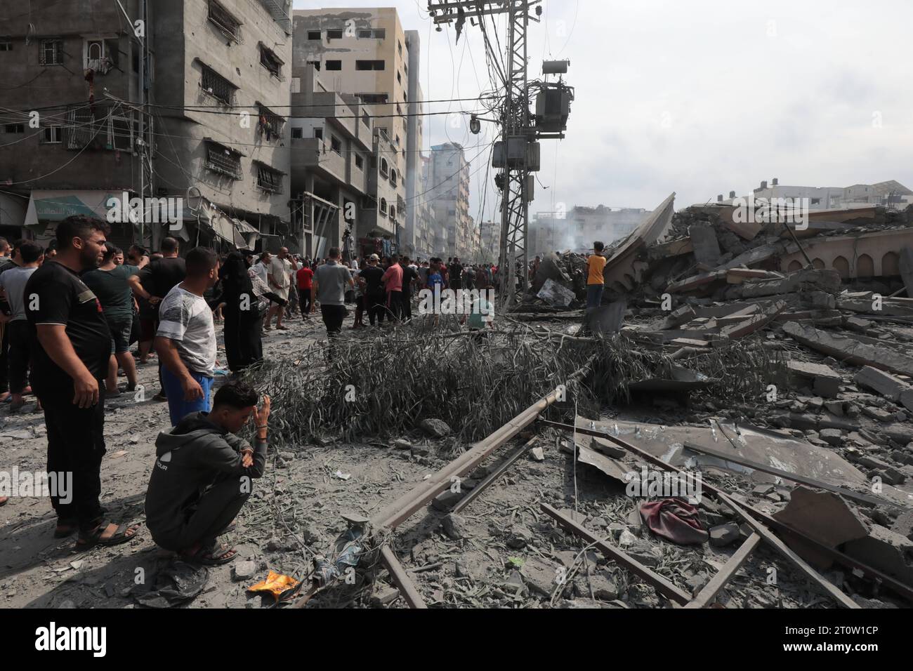 Palestinians inspect the damage following an Israeli airstrike on the ...