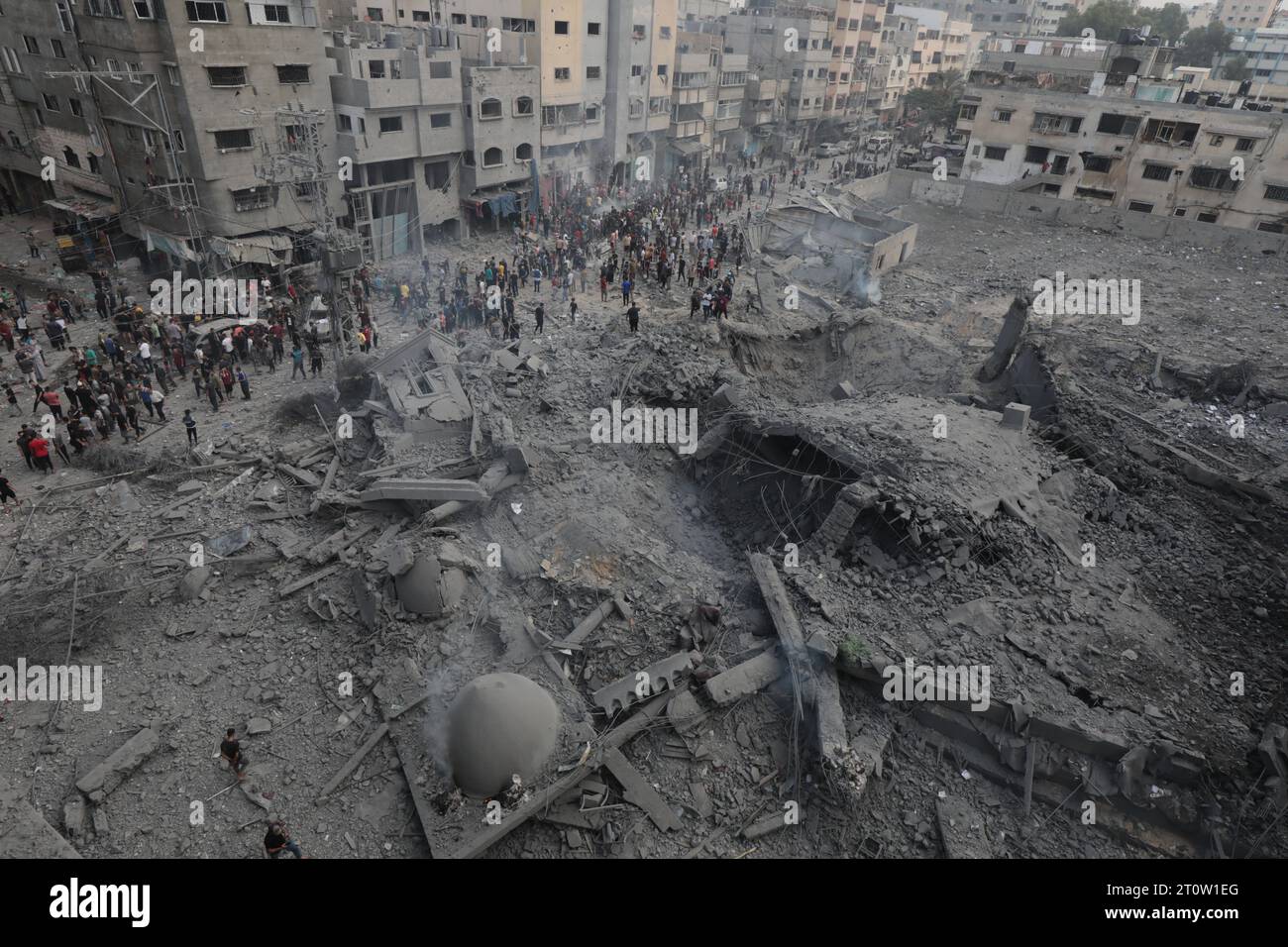 Palestinians inspect the damage following an Israeli airstrike on the ...