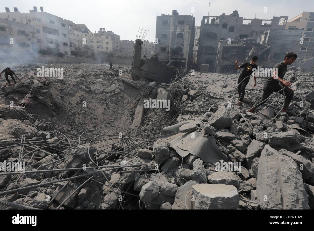 Palestinians inspect the damage following an Israeli airstrike on the ...