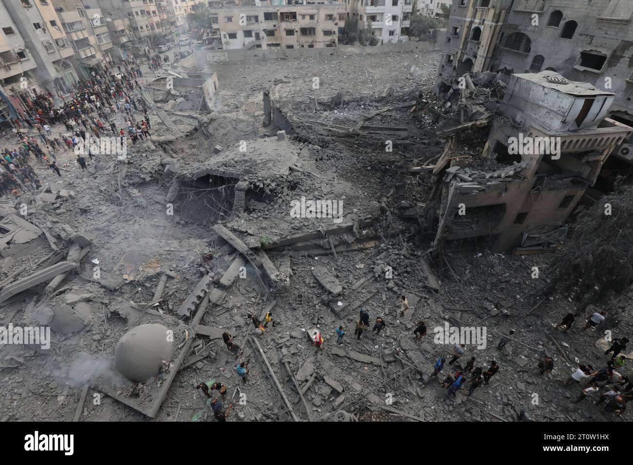 Palestinians inspect the damage following an Israeli airstrike on the ...