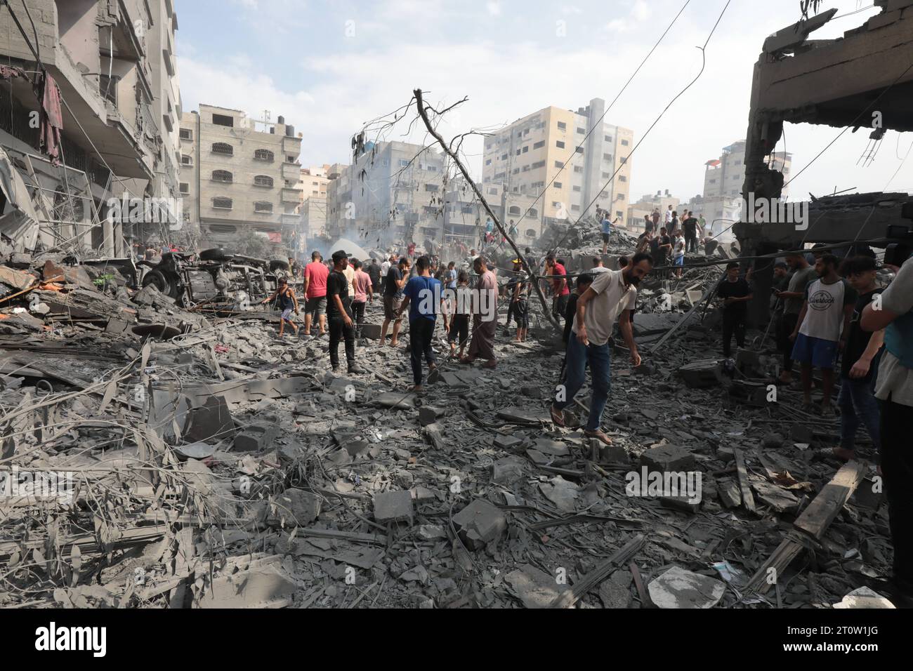 Palestinians inspect the damage following an Israeli airstrike on the ...