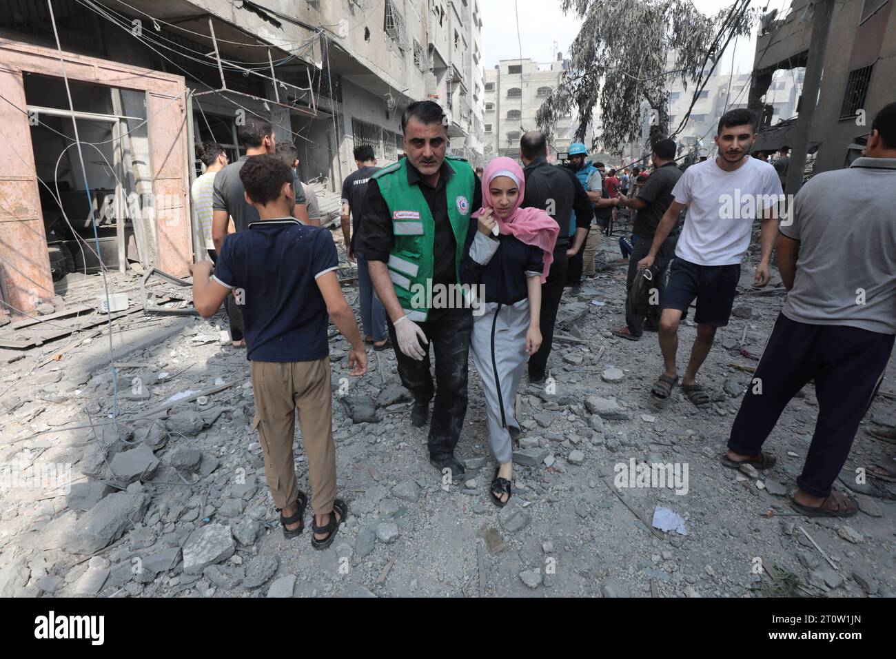 Palestinians inspect the damage following an Israeli airstrike on the ...