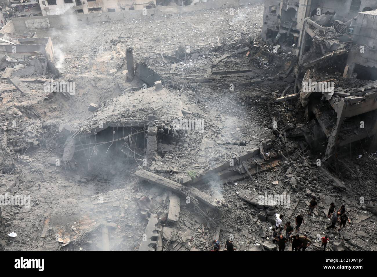 Palestinians inspect the damage following an Israeli airstrike on the ...