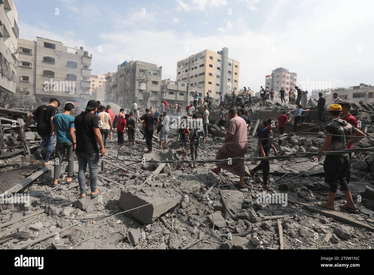Palestinians inspect the damage following an Israeli airstrike on the ...