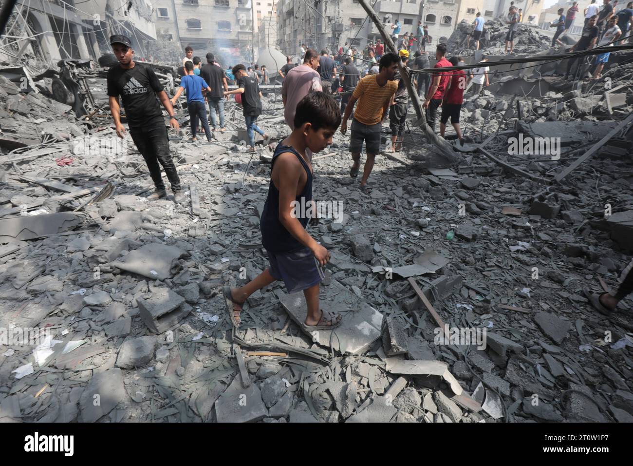 Palestinians inspect the damage following an Israeli airstrike on the ...