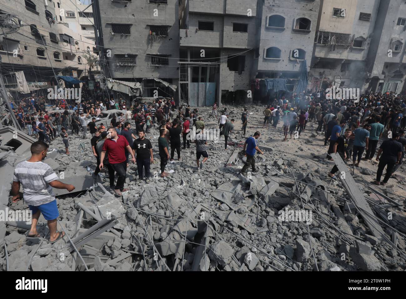 Palestinians inspect the damage following an Israeli airstrike on the ...