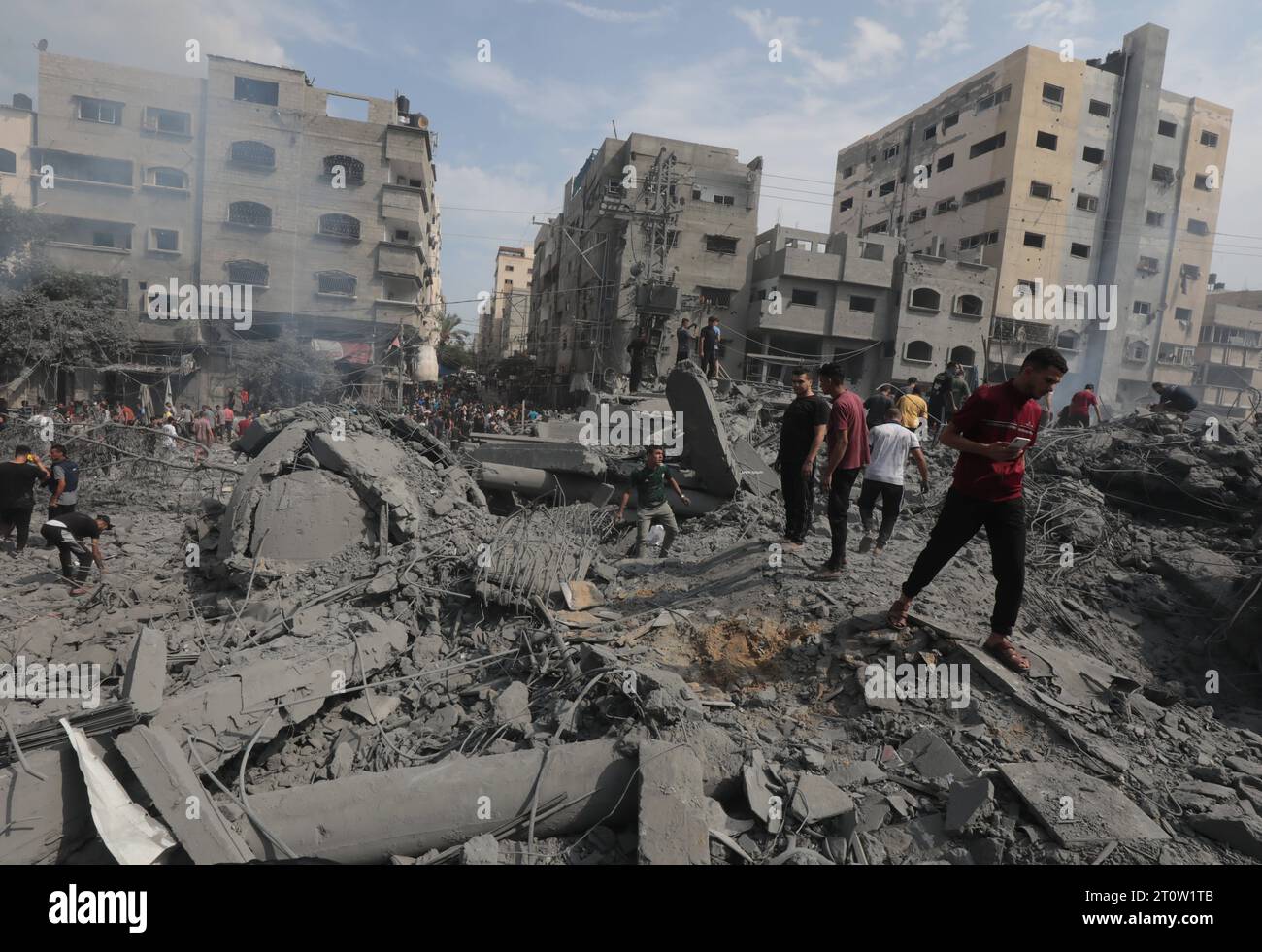 Palestinians inspect the damage following an Israeli airstrike on the ...
