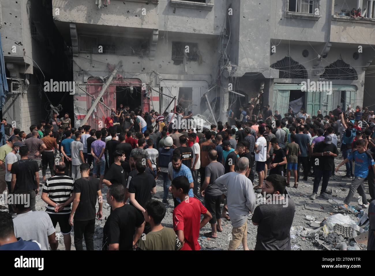 Palestinians inspect the damage following an Israeli airstrike on the ...