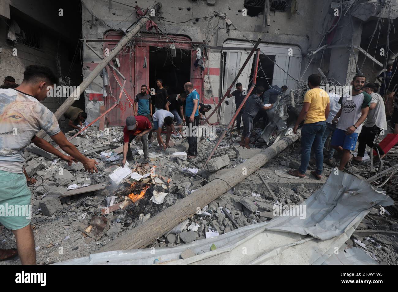 Palestinians inspect the damage following an Israeli airstrike on the ...