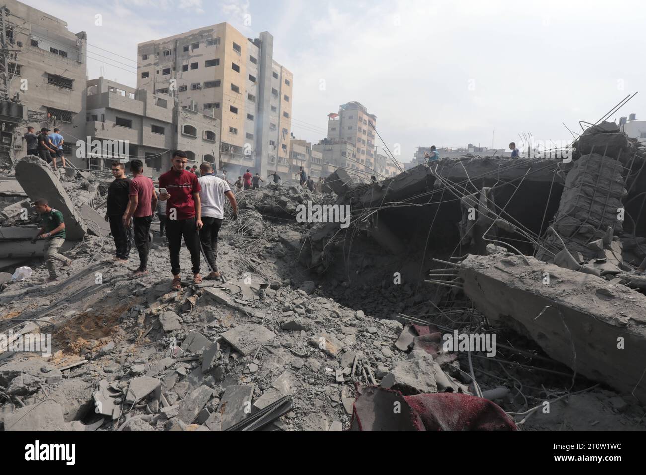 Palestinians inspect the damage following an Israeli airstrike on the ...